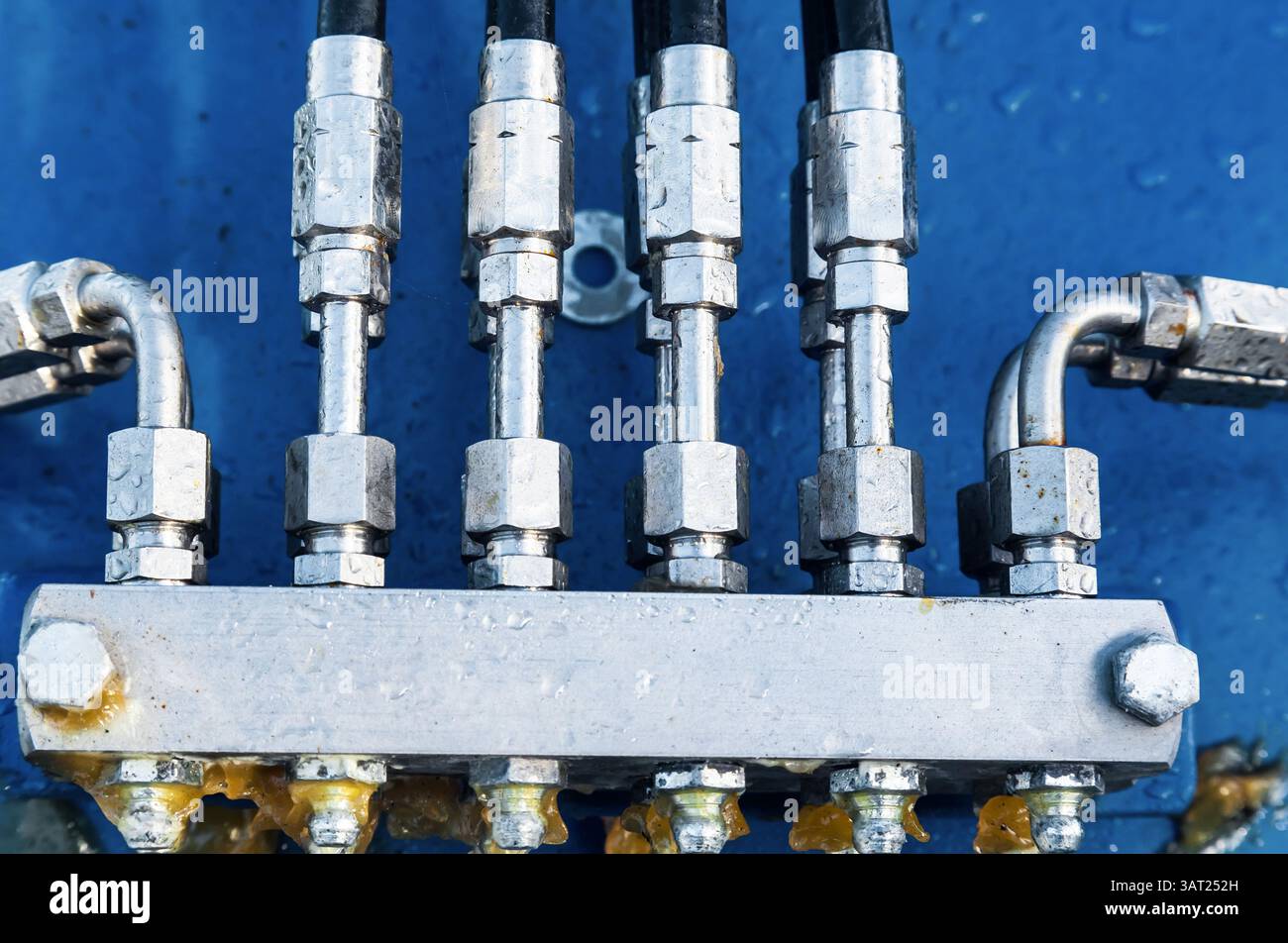 High pressure hydraulic hose system connected to steel pipes, close-up ...