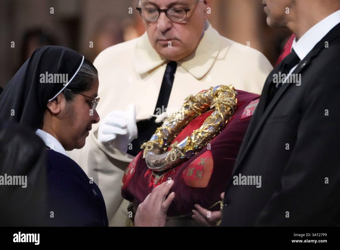 A nun touches the ancient relic that many Christians revere as Jesus ...