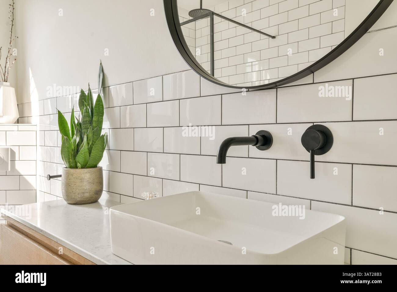 Stylish minimalist bathroom featuring a vessel sink, sleek faucet ...