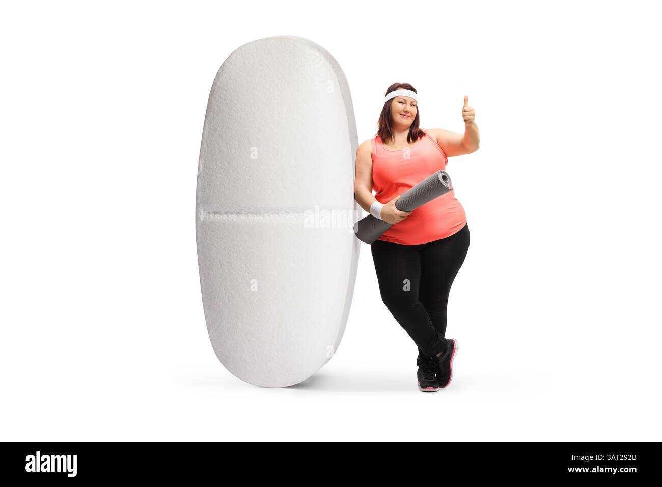 Plus size woman with an exercise mat leaning on a slimming pill ...