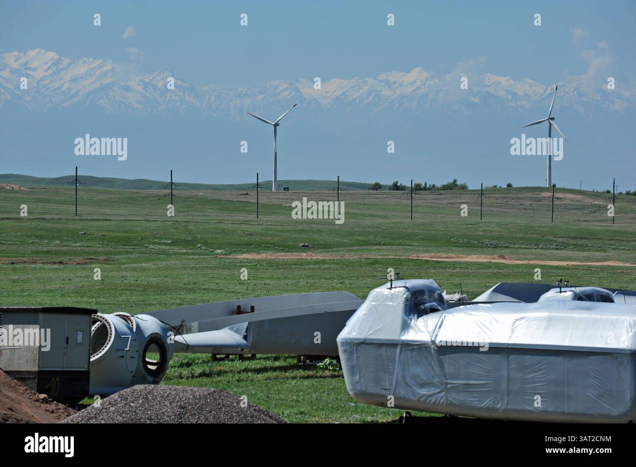 New parts of wind turbines are laid out in an open field for subsequent ...
