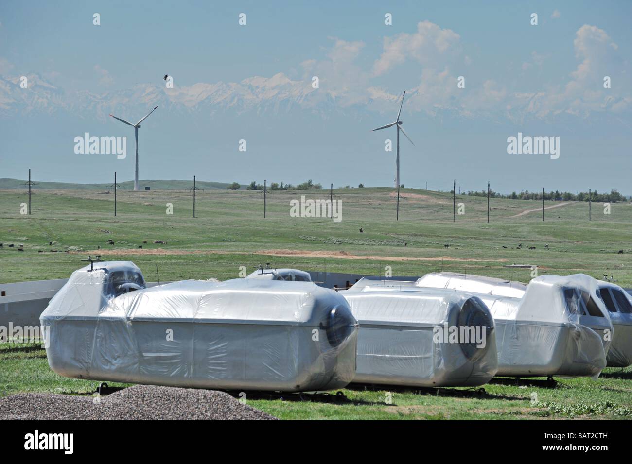 New parts of wind turbines are laid out in an open field for subsequent ...