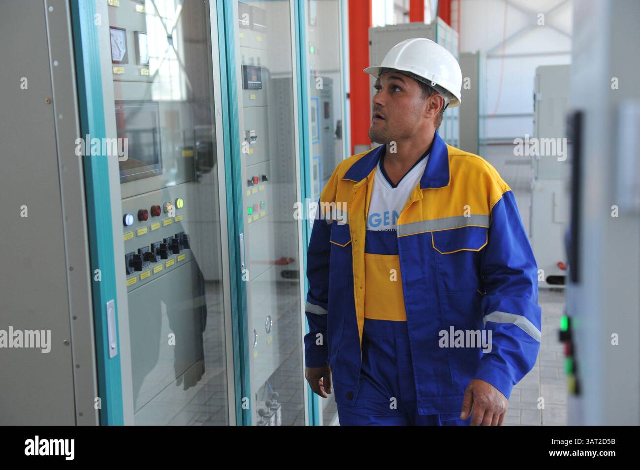 Hydroelectric power plant workers check different sections of the ...
