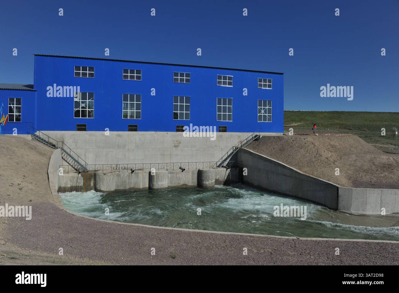 Dam water discharge bay on the background of the main building of the ...