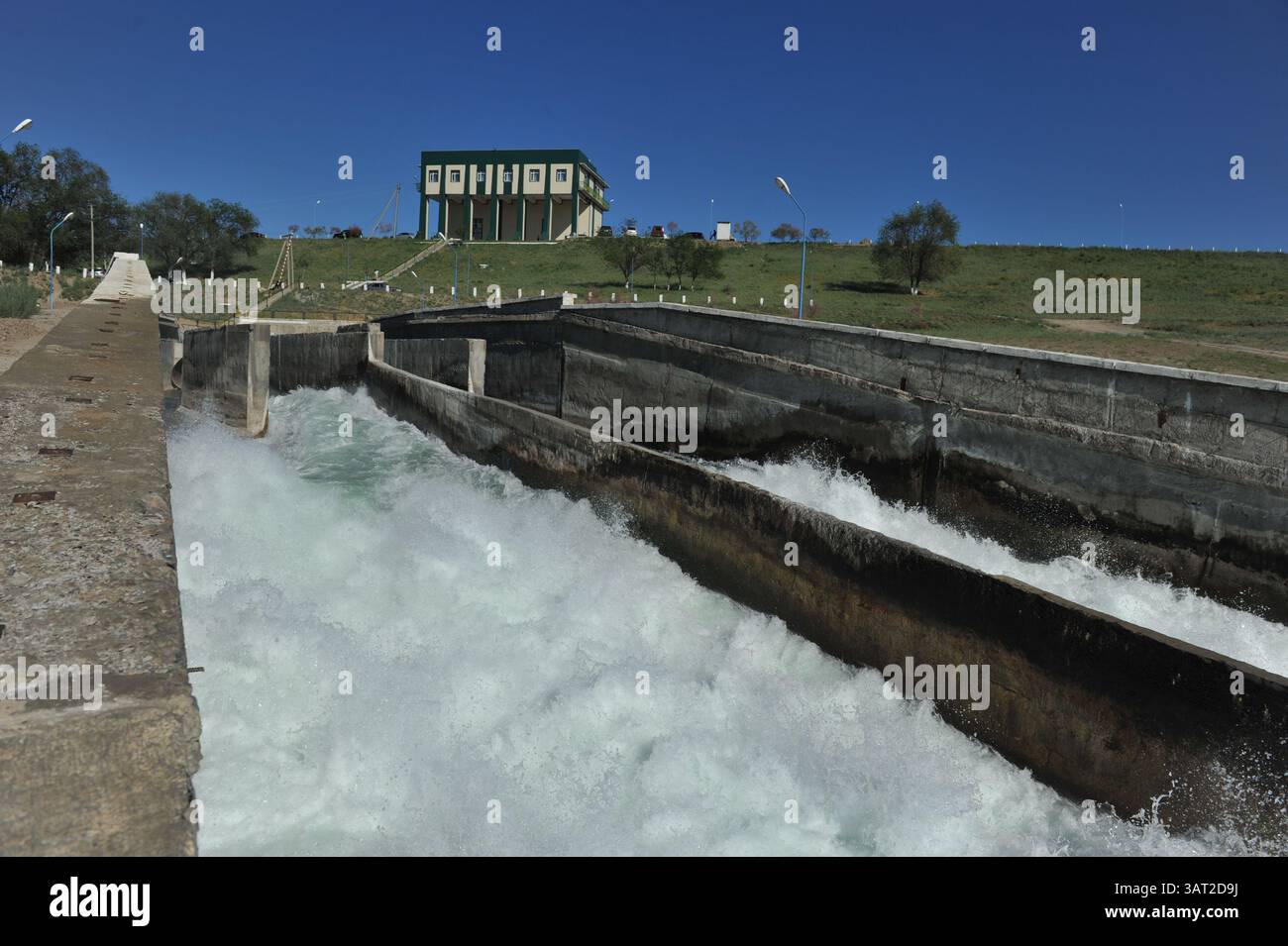 Dam water discharge bay on the background of the main building of the ...
