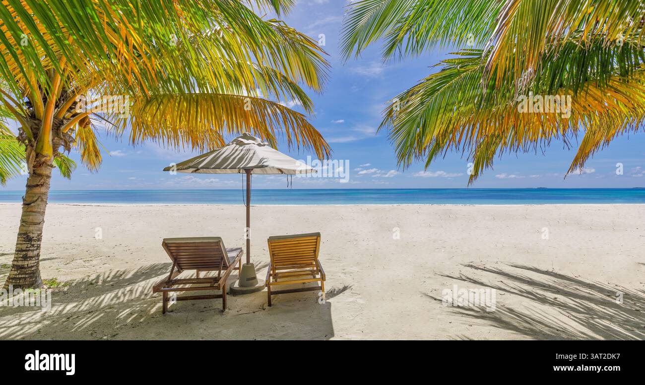 Sunny beach chairs umbrella romantic honeymoon destination. Love couple ...