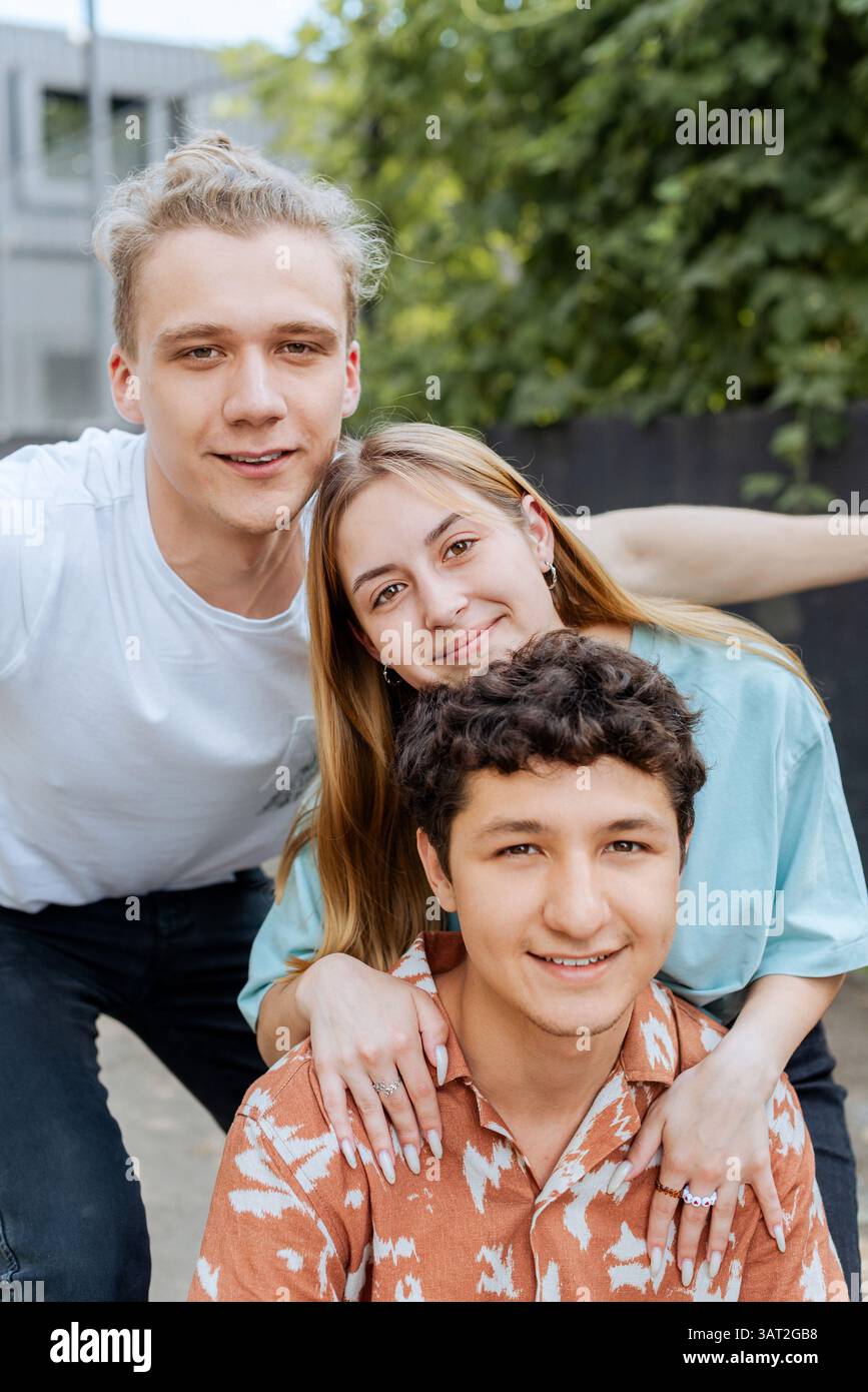Smiling teenagers posing outdoors with joy Stock Photo - Alamy