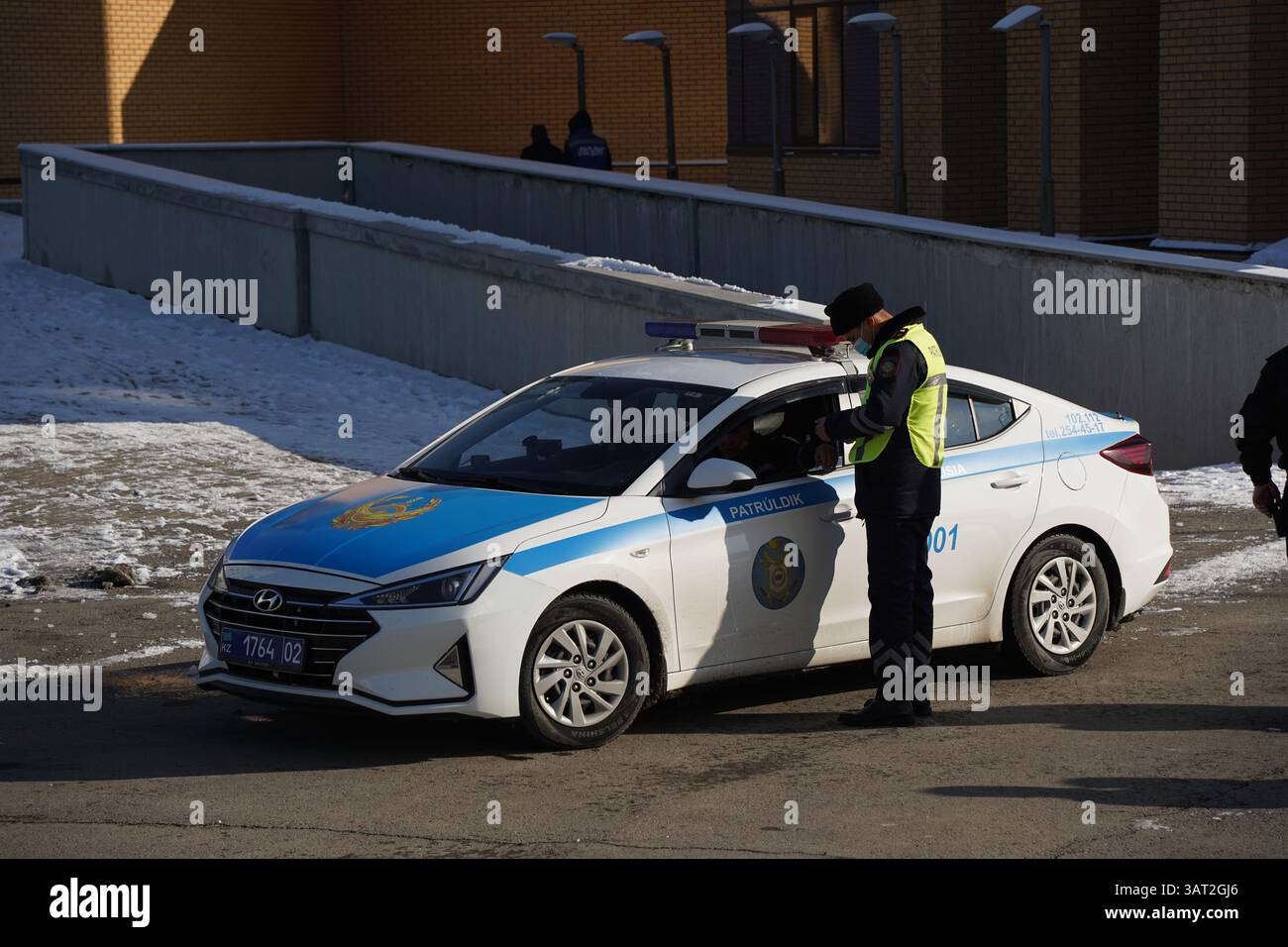 A police officer stands next to his official car Stock Photo - Alamy