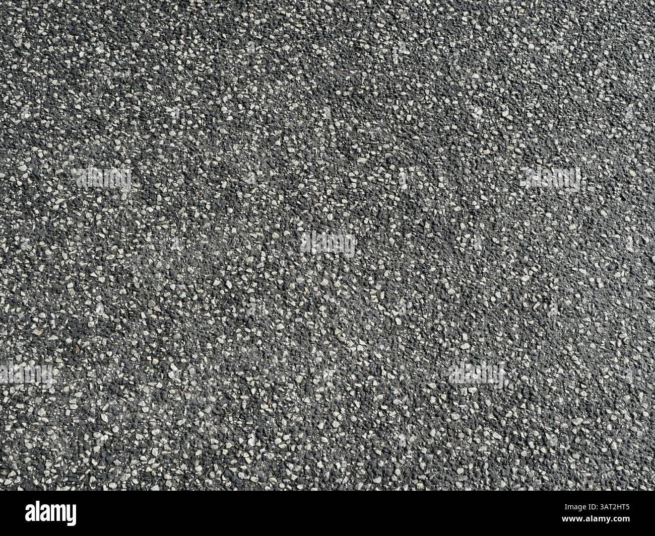 Asphalt road surface with white gravel ensures grip and safety ...