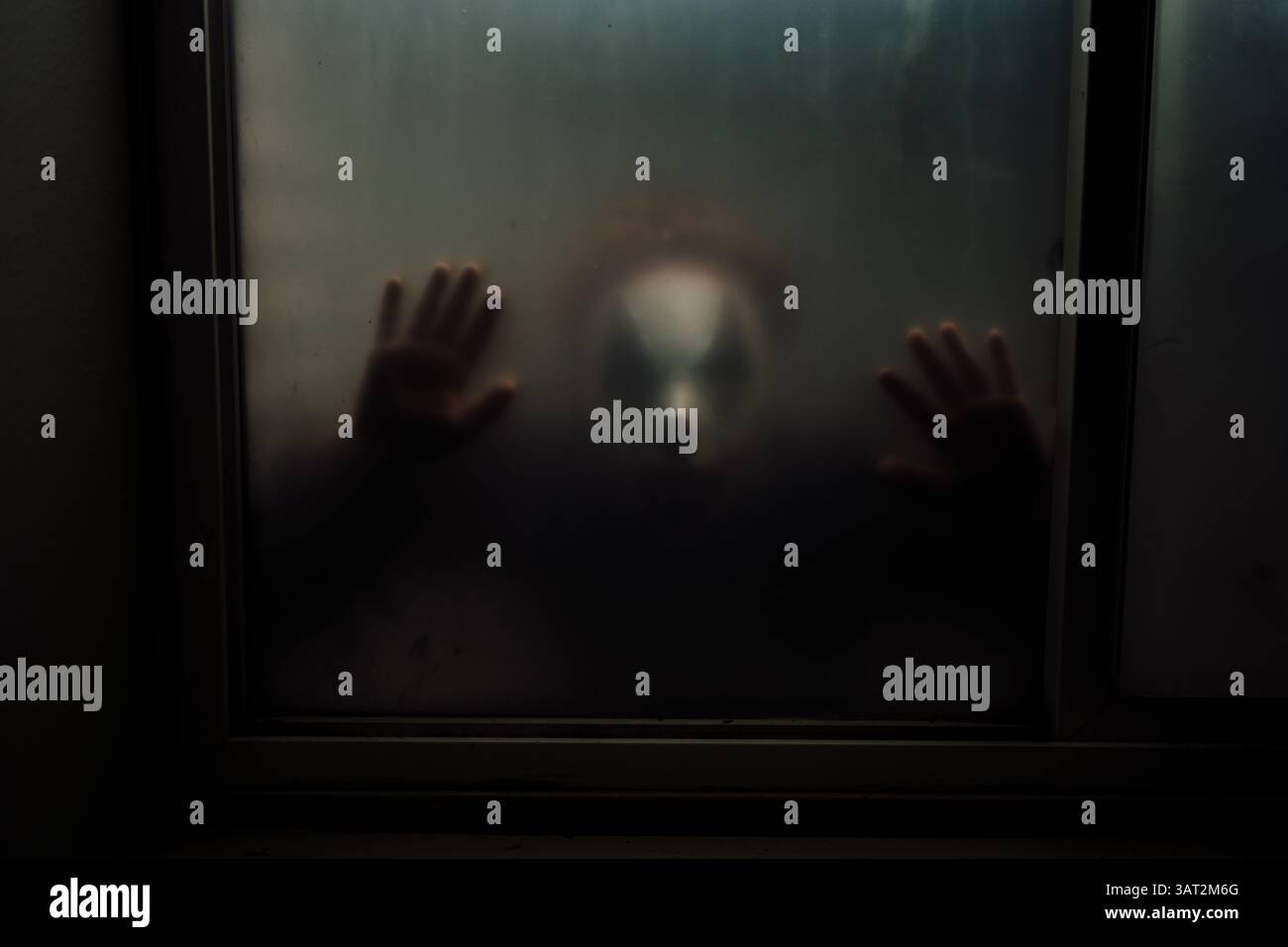 Creepy horror clown looks through dark window at home Stock Photo - Alamy