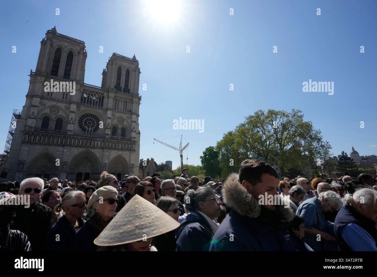 People attend the Way of Cross ceremony to mark Good Friday at Notre ...