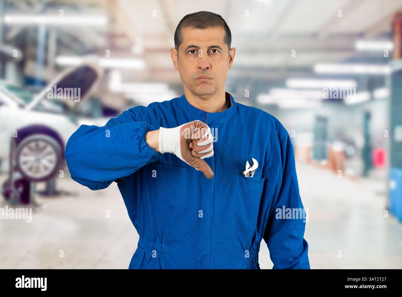 Mature caucasian man at repair shop wearing mechanic uniform with angry ...