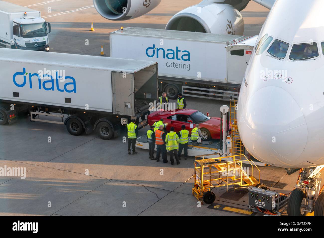Air cargo crew carefully unloading of a high performance Ferrari car ...