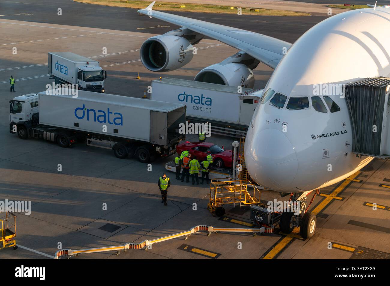 Air cargo crew carefully unloading of a high performance Ferrari car ...