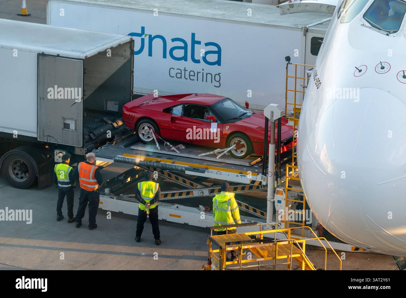 Air cargo crew carefully unloading of a high performance Ferrari car ...