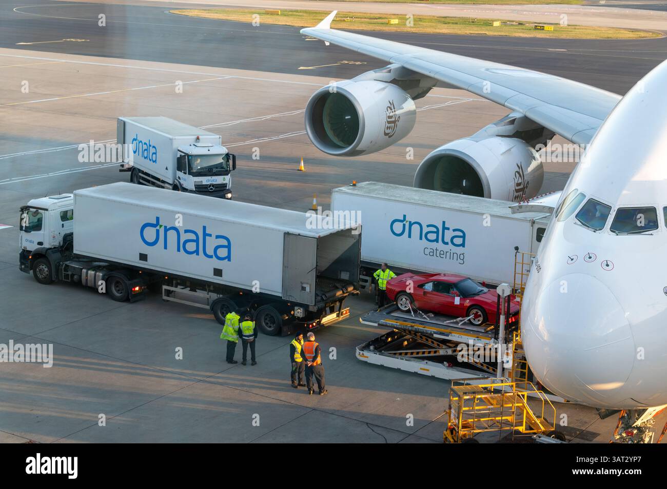 Air cargo crew carefully unloading of a high performance Ferrari car ...