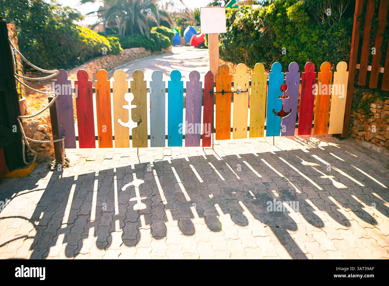 Small colorful wooden gate made of vertical planks painted in different ...