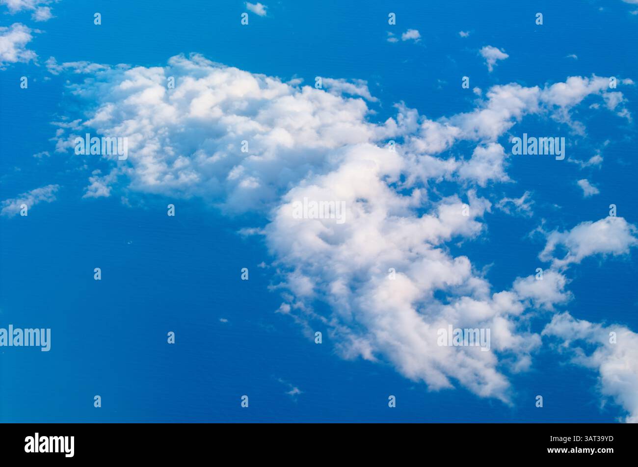 Vibrant blue sky stretched endlessly, filled with clusters of fluffy ...