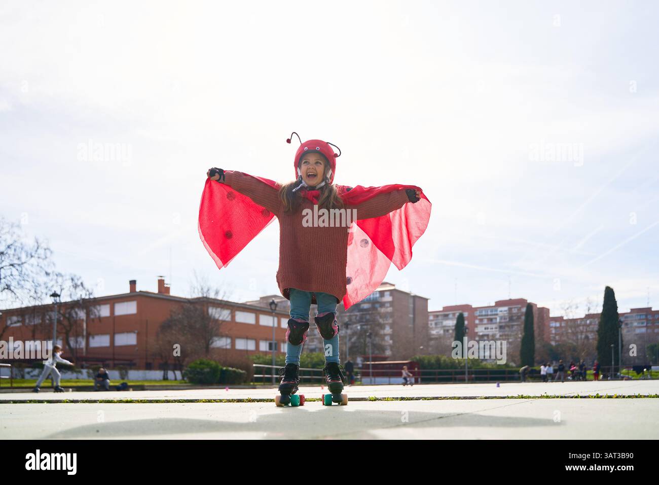 Girl wearing ladybug costume with helmet and protections roller skating ...