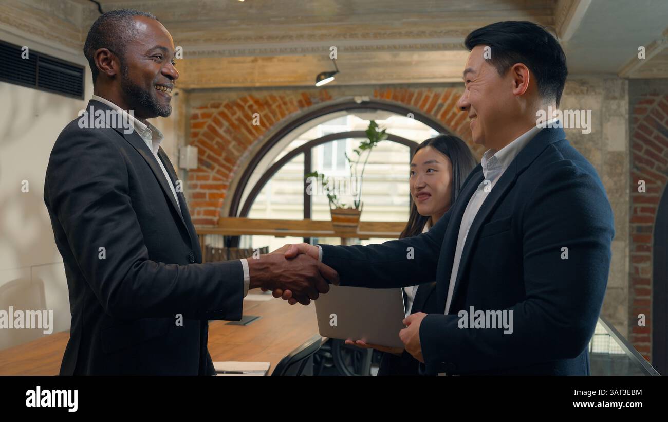 Three multiracial colleagues coworkers business people talking in ...