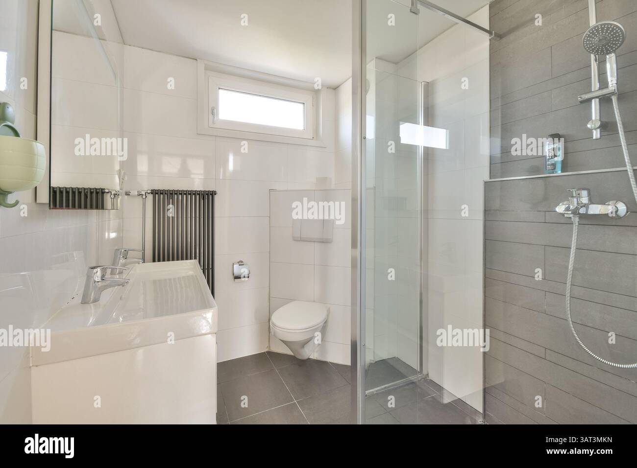 A sleek, contemporary bathroom featuring a glass shower enclosure ...