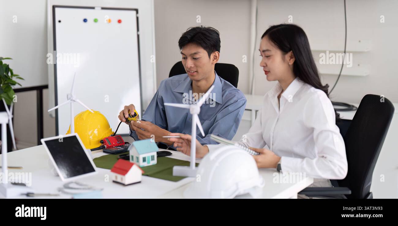 Teamwork and Sustainable Design. Engineers work on eco-conscious ...