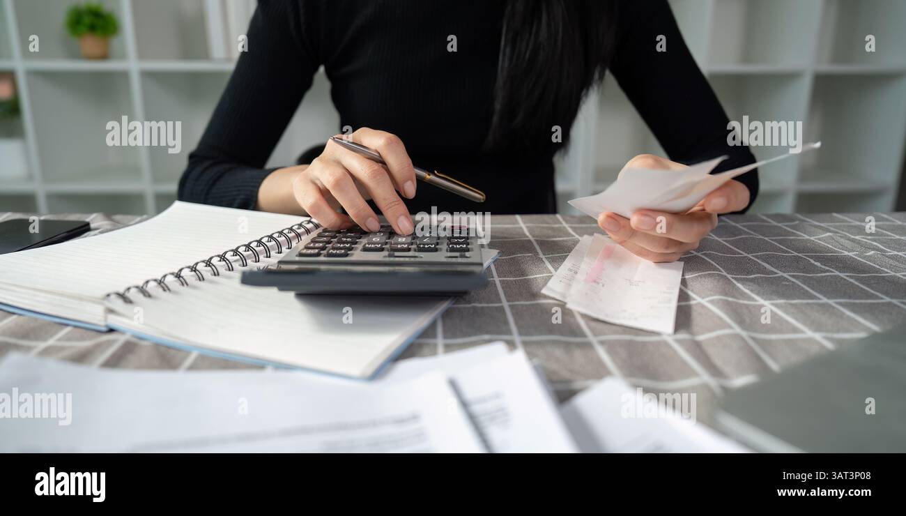 Budgeting and Financial Management. A person calculating bills using a ...