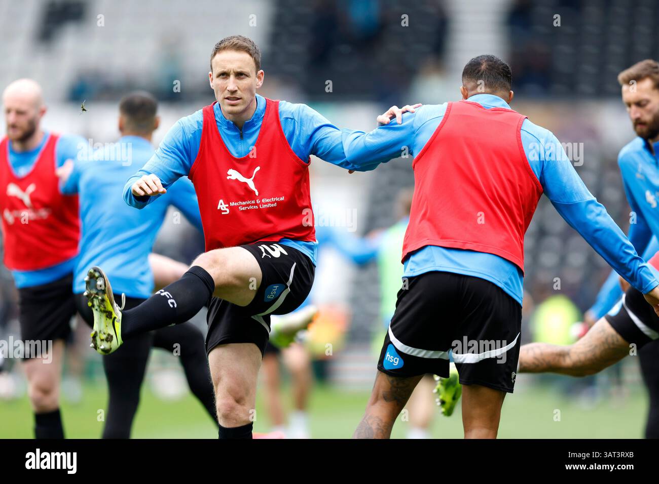 Derby County's Craig Forsyth (left) and team-mates warming up prior to ...