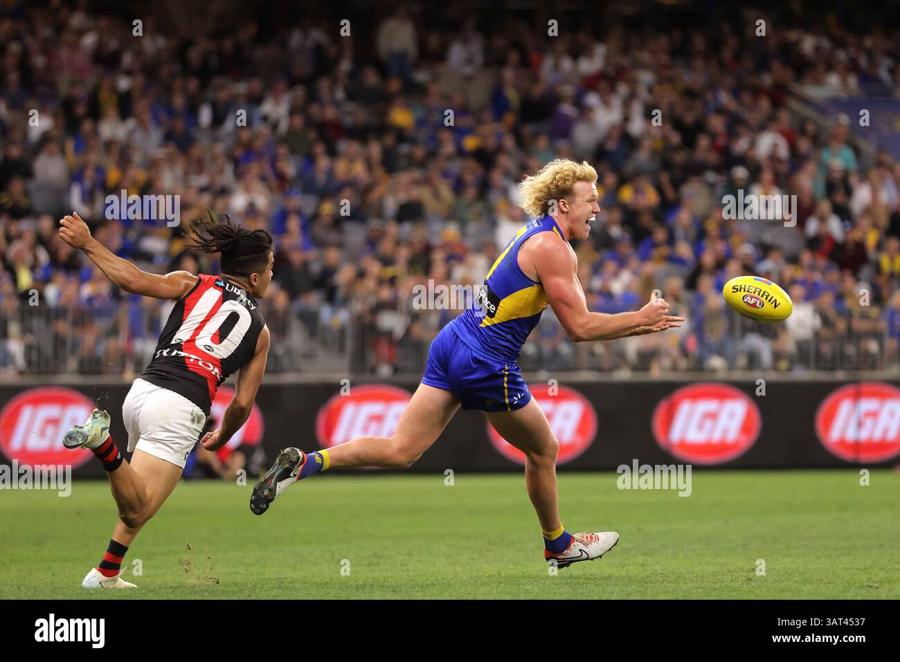 Perth, Australia. 18th Apr, 2025. Reuben Ginbey of the Eagles handballs ...