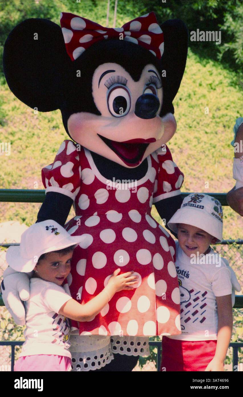 Anaheim, CA, USA, approx. 1985. Children posing with Minnie Mouse at ...