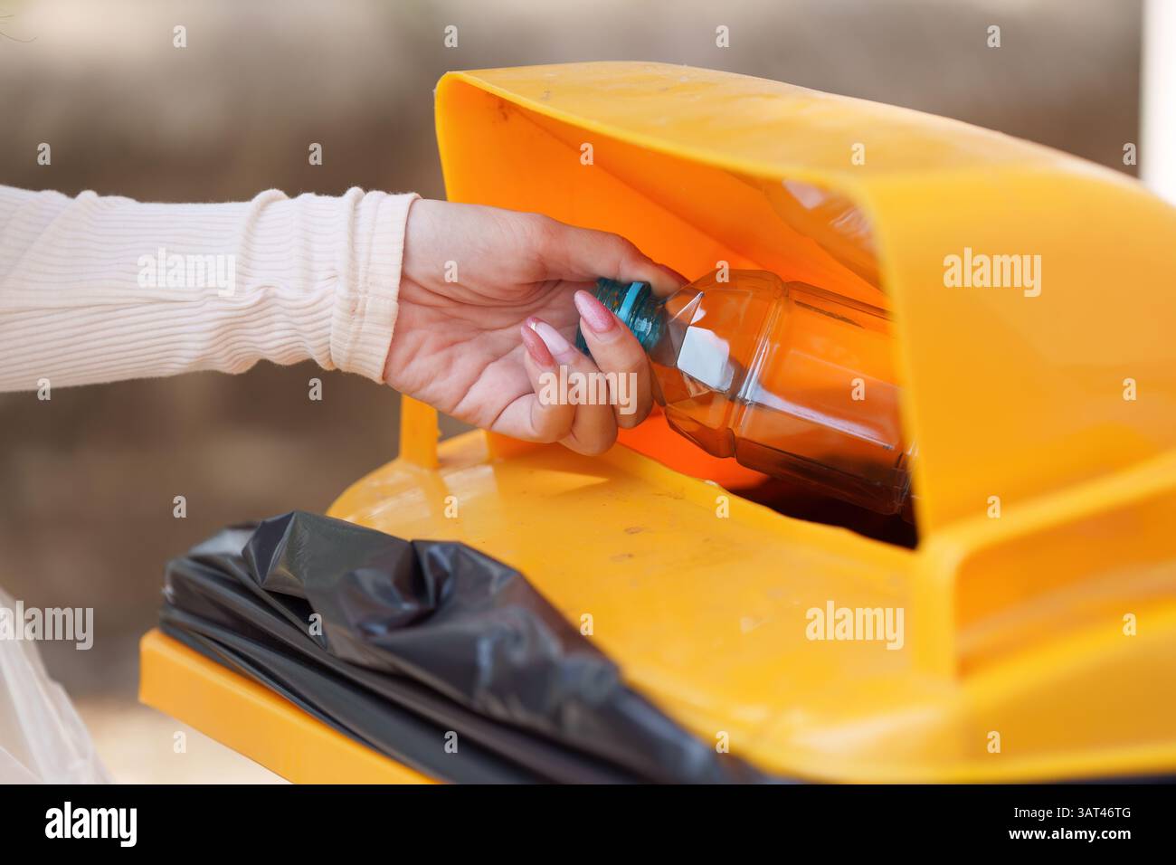 Recycling and Waste Management. An individual disposing of a plastic ...