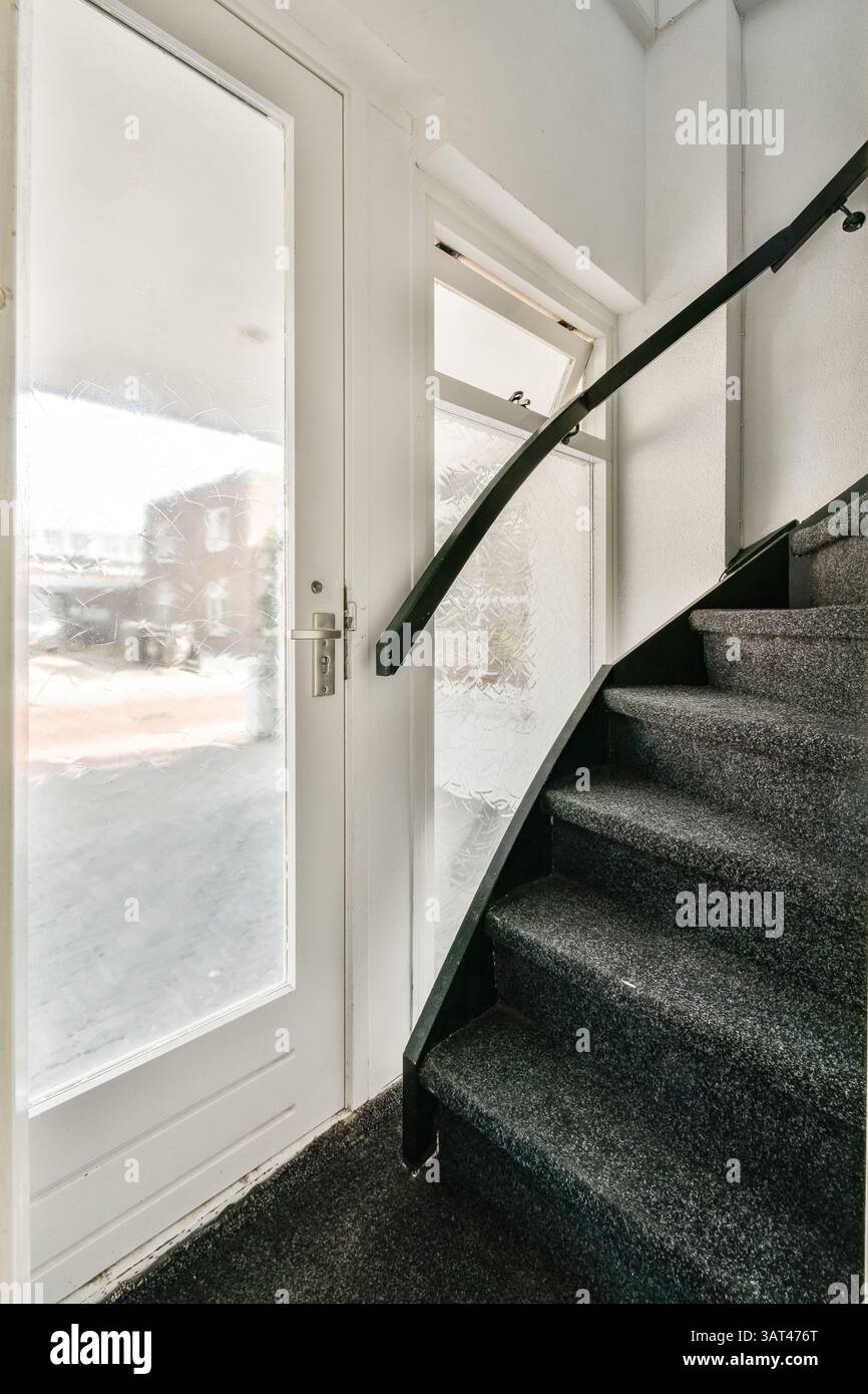 A sleek interior featuring a spiral staircase and a contemporary glass ...