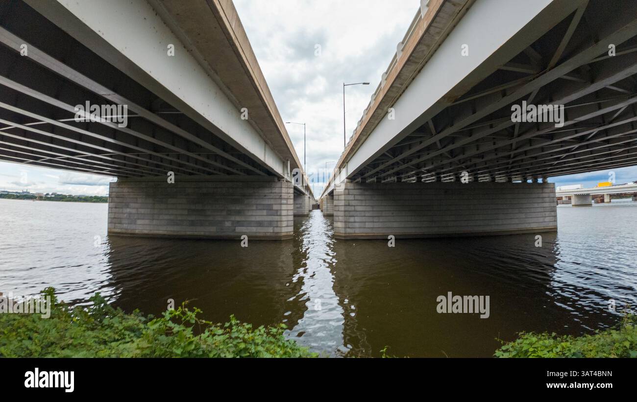 The bridge is very long and has a lot of water underneath it. The water ...