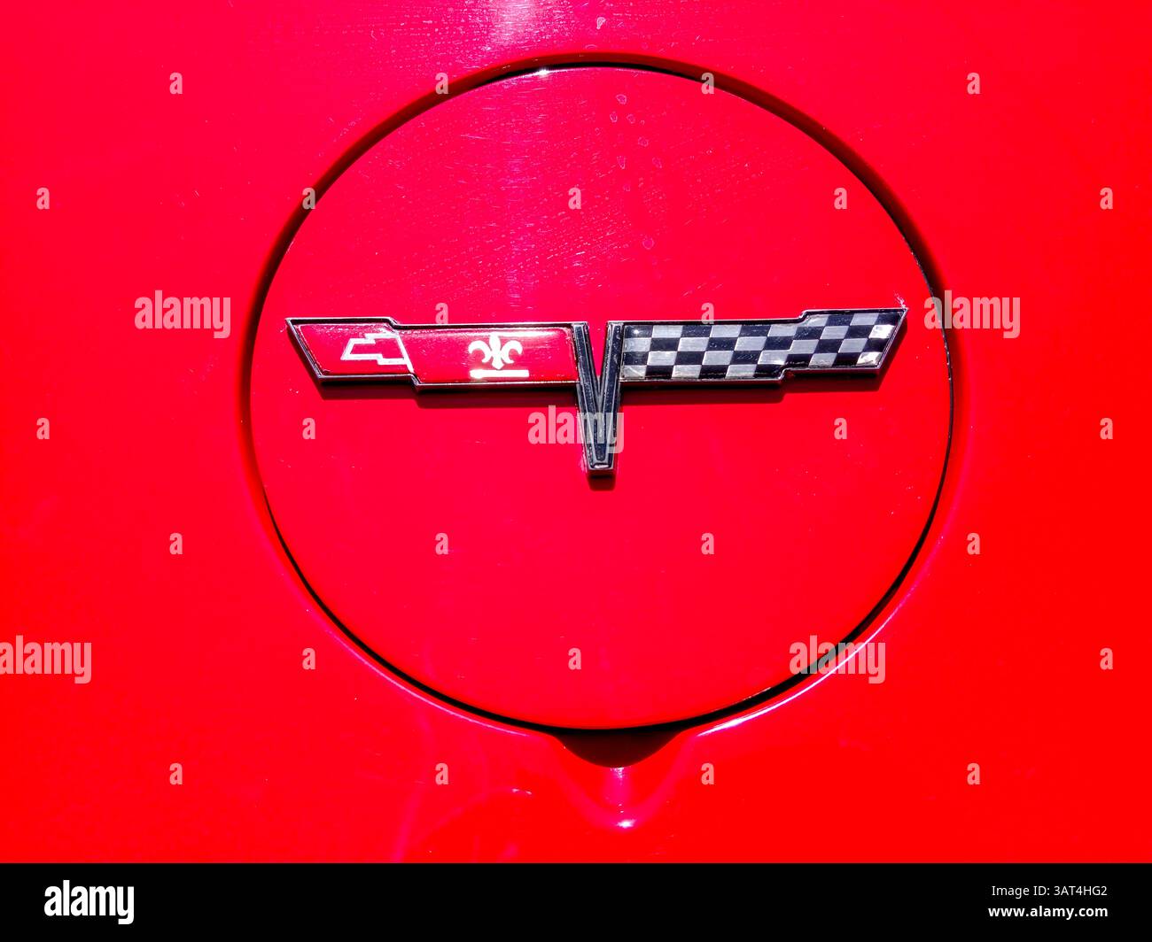 Close up of a red corvette's gas cap, showcasing the iconic racing flag ...