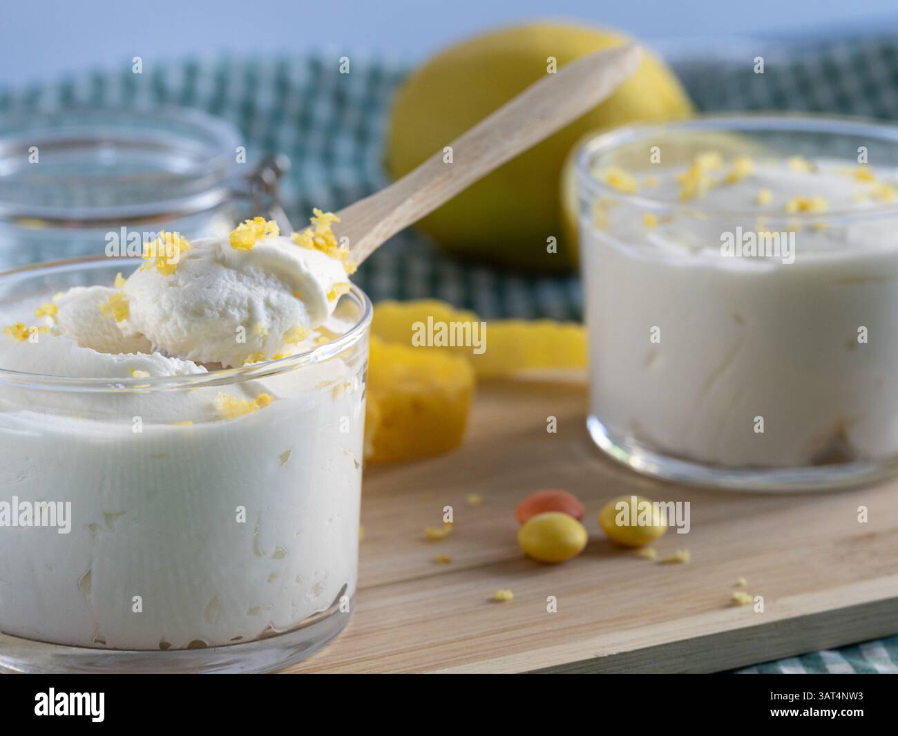 Creamy lemon mousse served in small dessert glasses. Natural light ...
