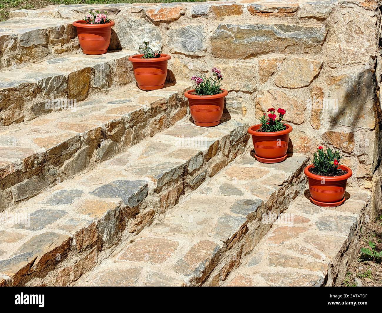 Terracotta Harmony: Cascading Flower Pots Stock Photo - Alamy