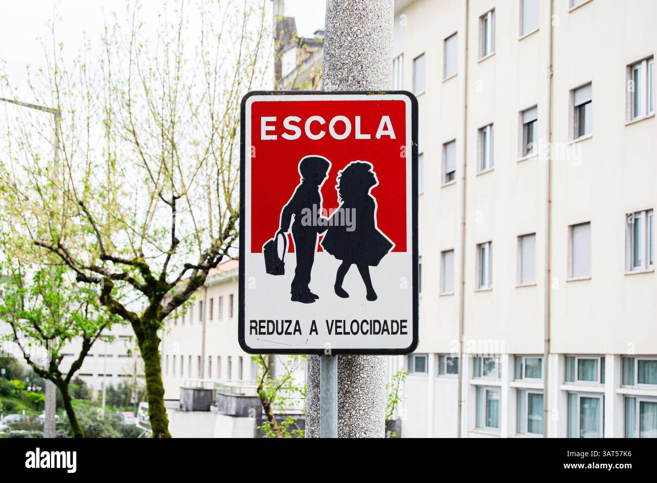 Portuguese school zone sign urging drivers to reduce speed near ...