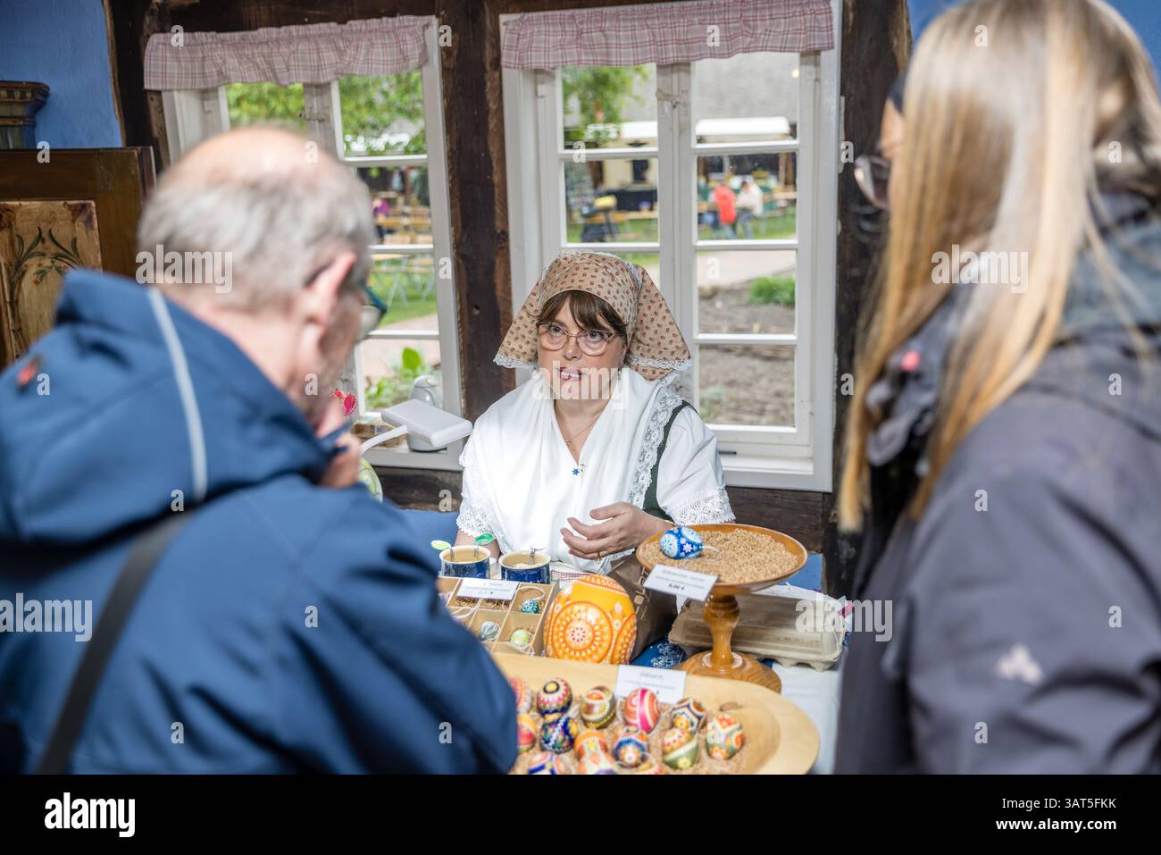 Lehde, Germany. 18th Apr, 2025. Martina Hofmann explains the egg ...