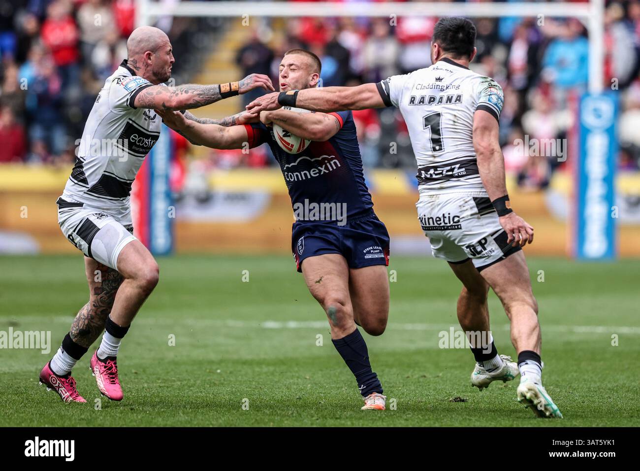 Hull, UK. 18th Apr, 2025. Mikey Lewis of Hull KR is tackled by Jordan ...