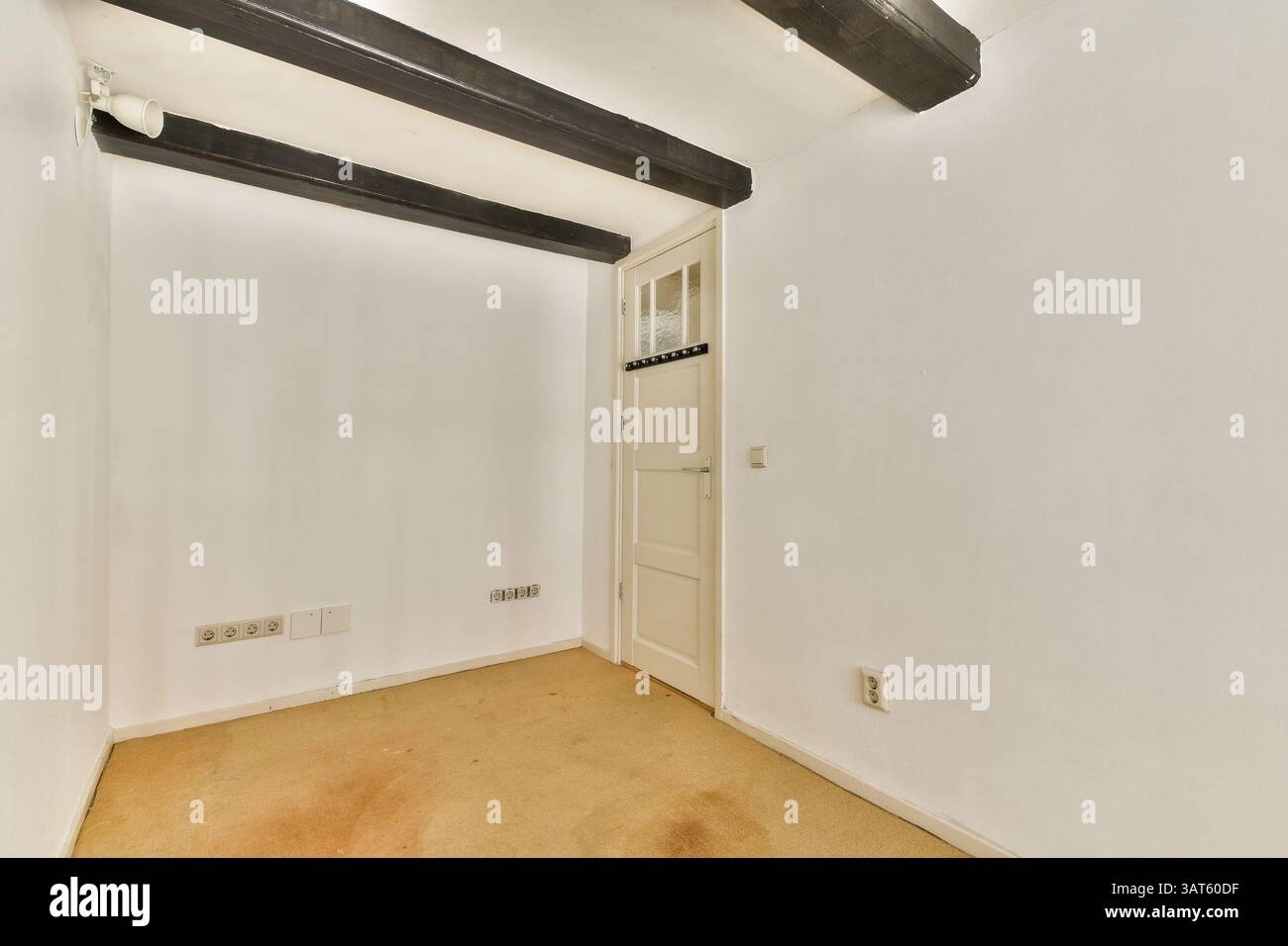 A minimalistic interior room featuring white walls, wooden beams, and a ...