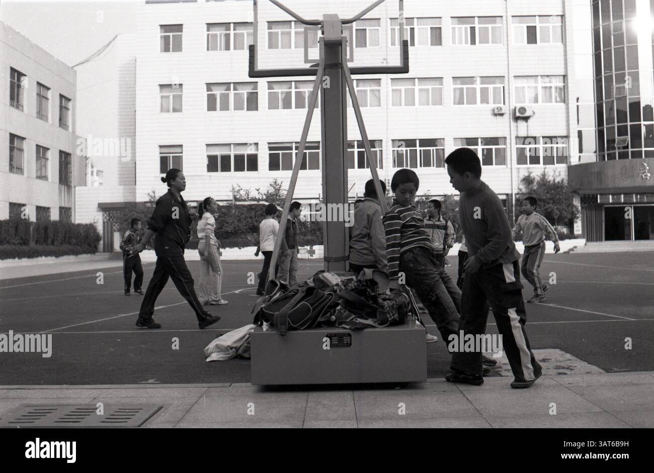 Children enjoying a lively basketball game on a school playground ...