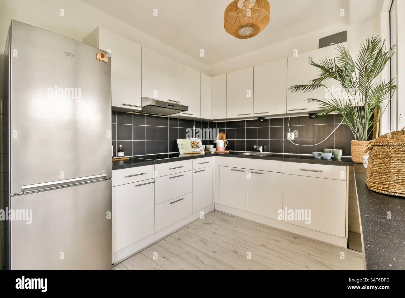 Sleek and stylish kitchen featuring a blend of white cabinets and dark ...