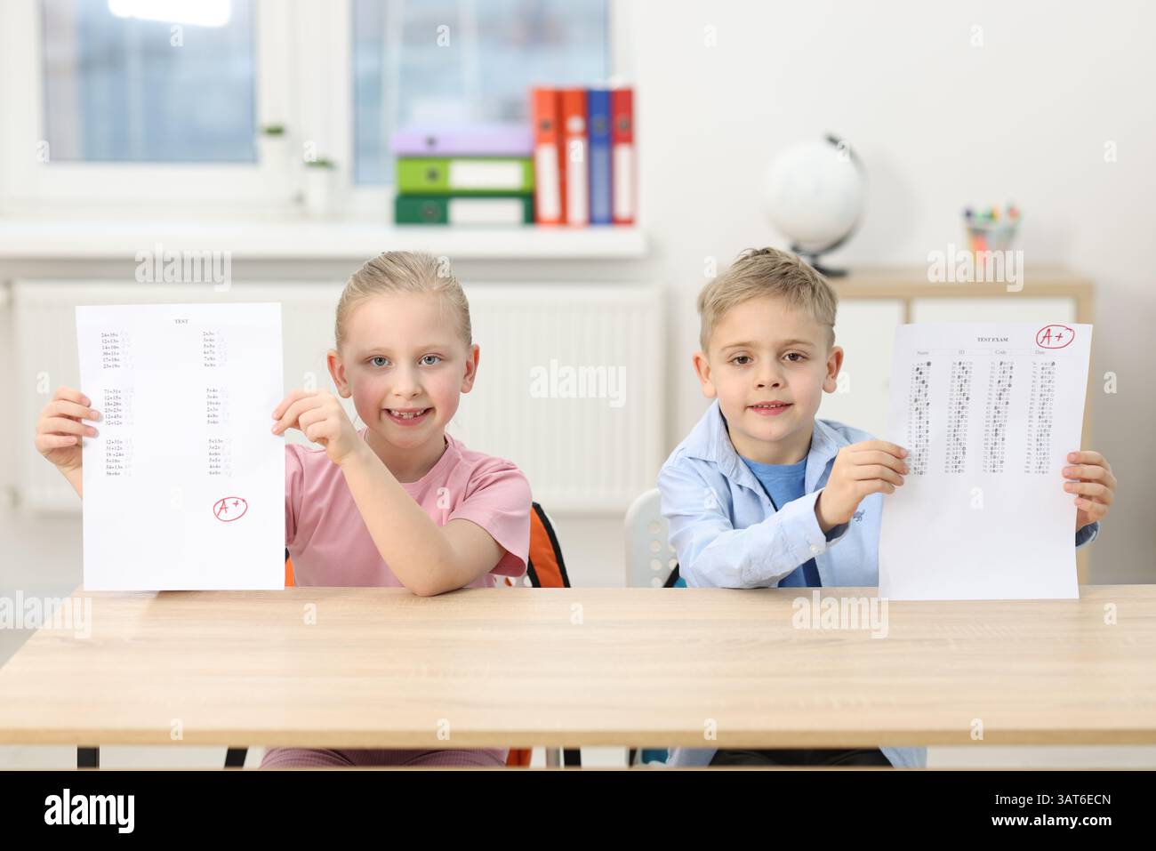 School grade. Happy kids holding answer sheets with excellent marks at ...