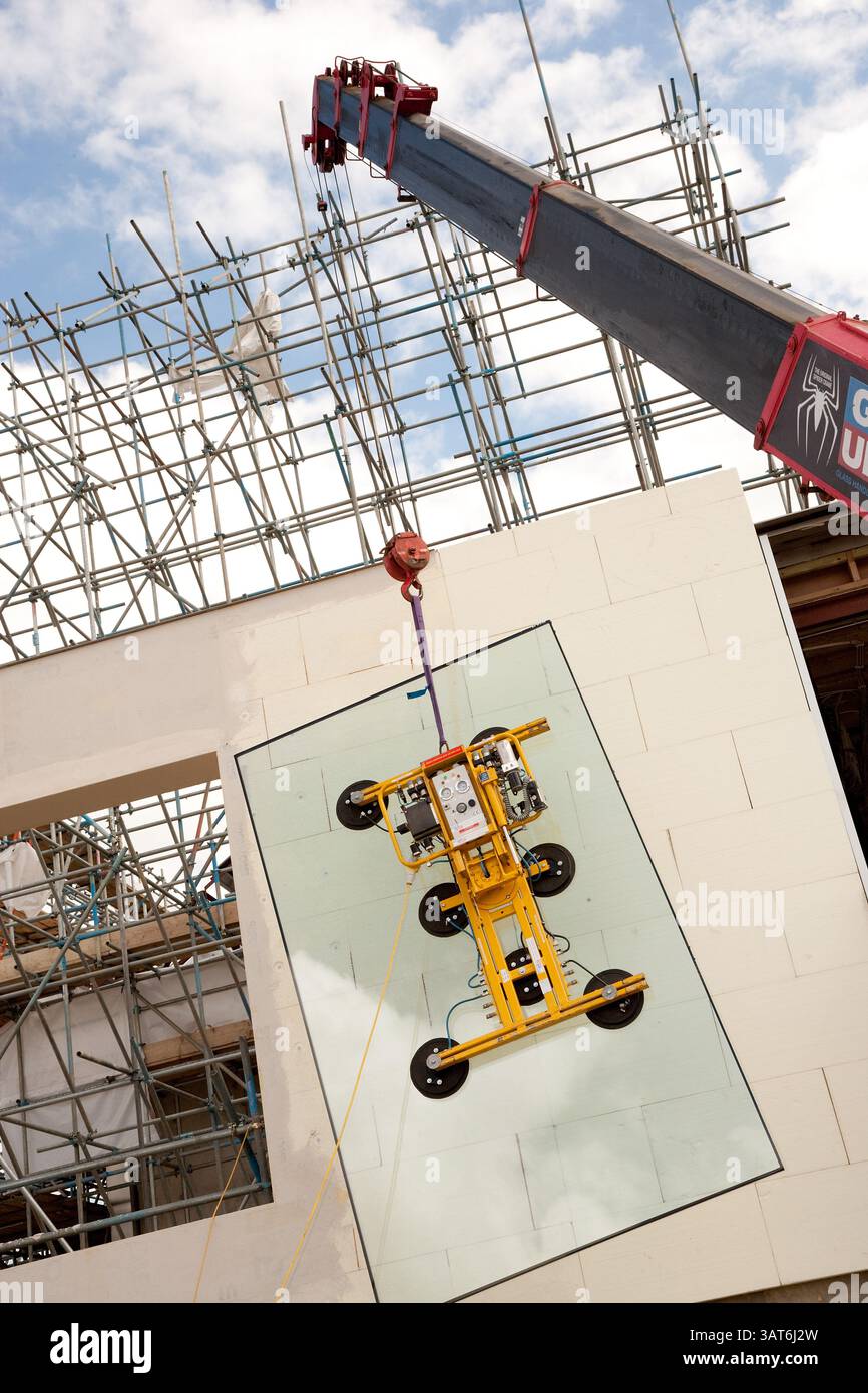 Installation of large glass panel on a building construction site Stock ...