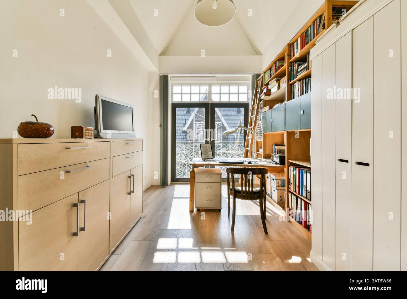A bright and spacious study room featuring a stylish desk, shelves ...