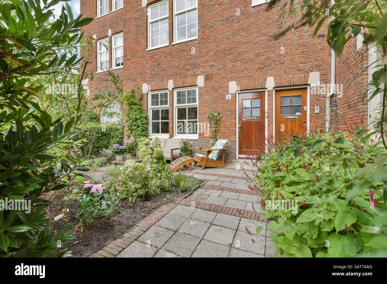 A picturesque front yard features lush greenery and colorful flowers ...