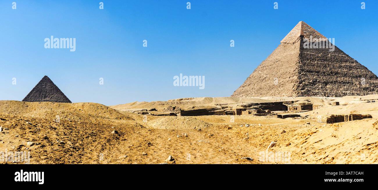 Two iconic pyramids in the desert under a clear blue sky, showcasing ...