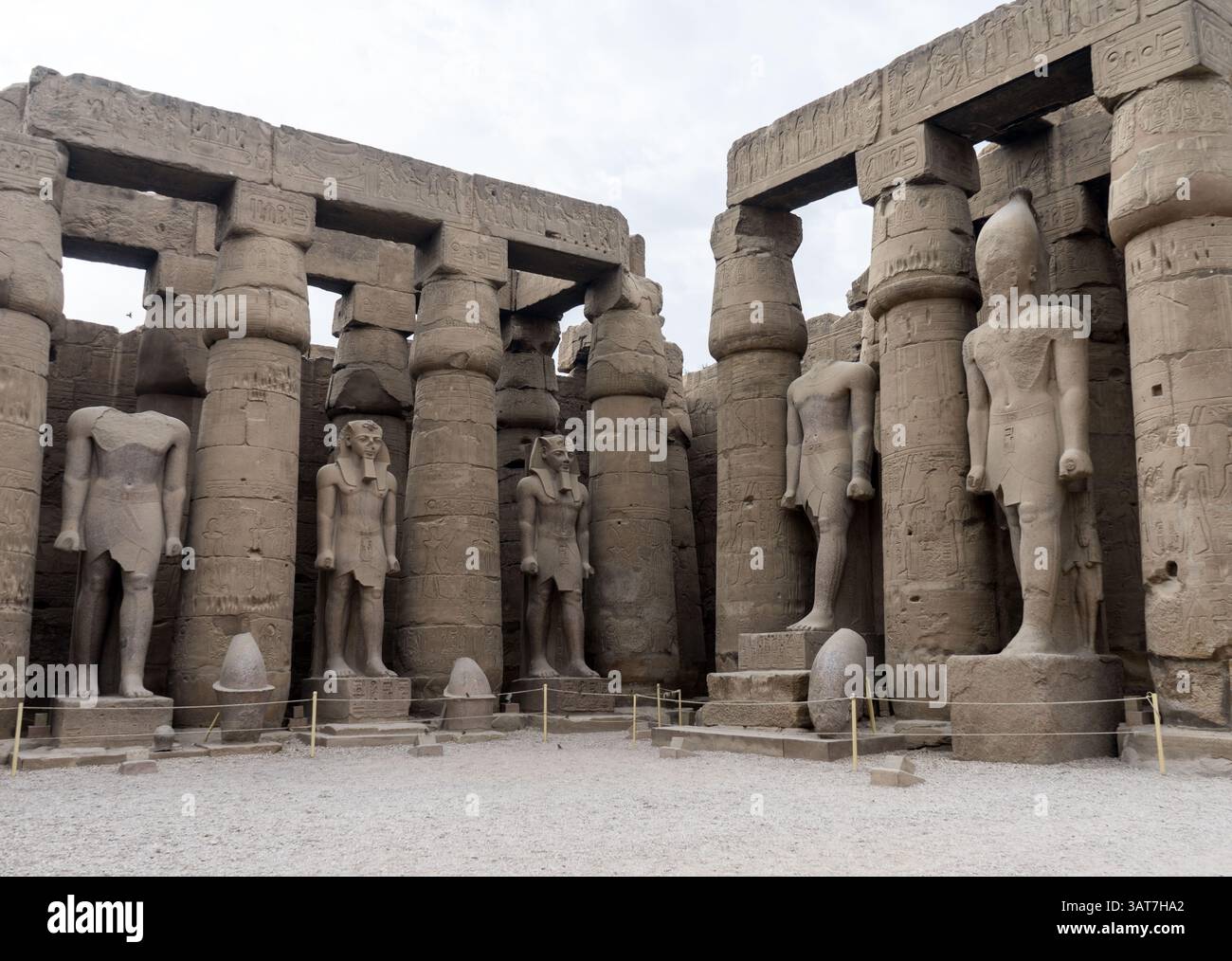 Ancient Egyptian temple ruins featuring large stone statues and columns ...