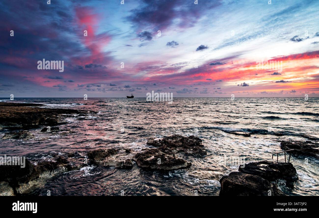 Sunset over rocky coastline hi-res stock photography and images - Alamy