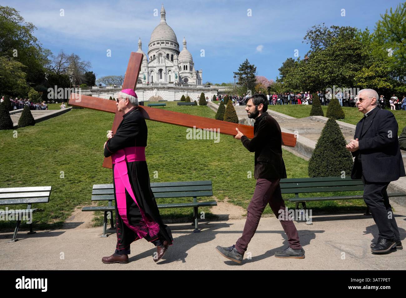 Paris Archbishop Laurent Ulrich, left, carries a cross during the Way ...